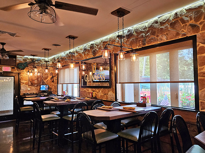 Pendant lights cast a warm glow over stone walls that have witnessed countless "mmm" moments. The Guinness sign promises this place takes beverages as seriously as its food.