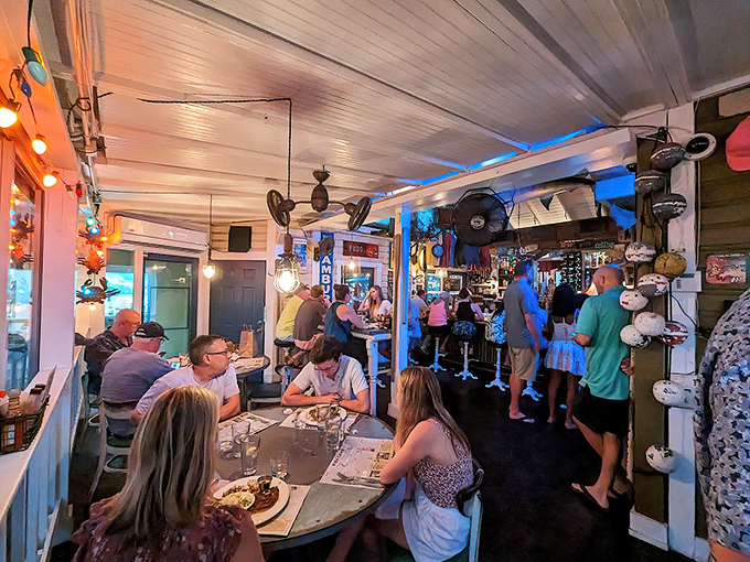 Inside Owen's, time stands still as diners huddle around weathered tables beneath a ceiling festooned with coastal memorabilia. Florida dining at its most authentic.