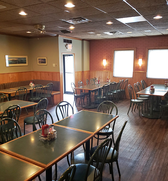 Wood paneling, brick walls, and no-nonsense tables create that perfect "come as you are" vibe where comfort trumps pretension every time.