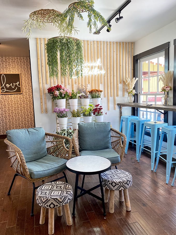 Indoor garden meets boho chic&mdash;hanging plants cascade from the ceiling while wicker chairs invite you to sink in and stay awhile.