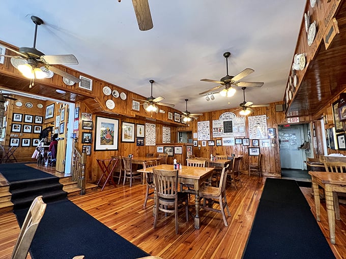 Wood-paneled walls adorned with memories tell stories of satisfied diners past, while ceiling fans lazily spin above tables awaiting new seafood adventures.