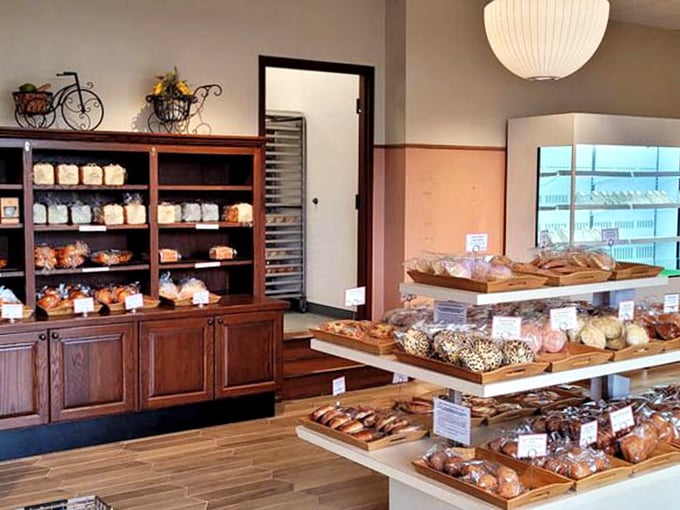 Wooden shelves lined with freshly baked treasures &ndash; this isn't just a bakery display, it's a museum of carbohydrate artistry.