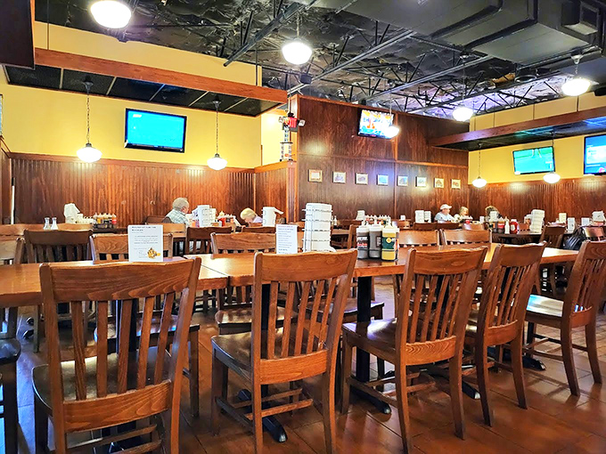 Wooden chairs, warm lighting, and TVs strategically placed for game day. This dining room isn't trying to be fancy&mdash;it's trying to make you comfortable while you feast.