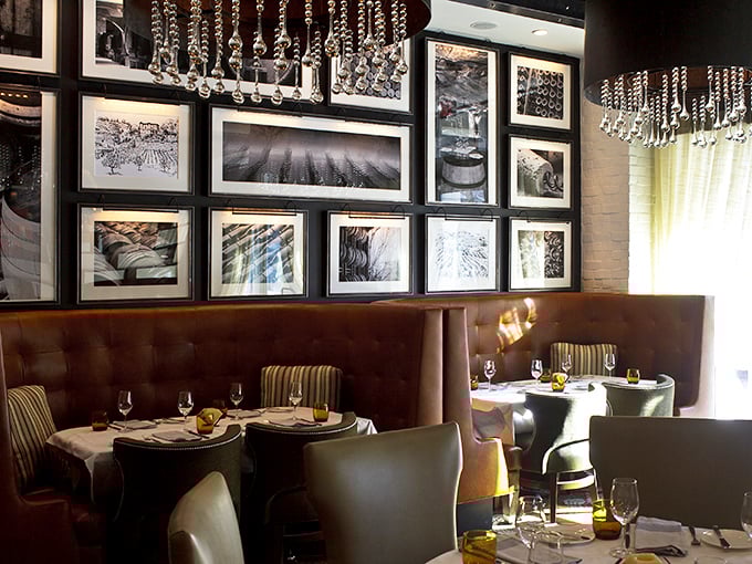 Rich leather booths and crystal chandeliers create the perfect backdrop for culinary drama, where every table feels like the best seat in the house.