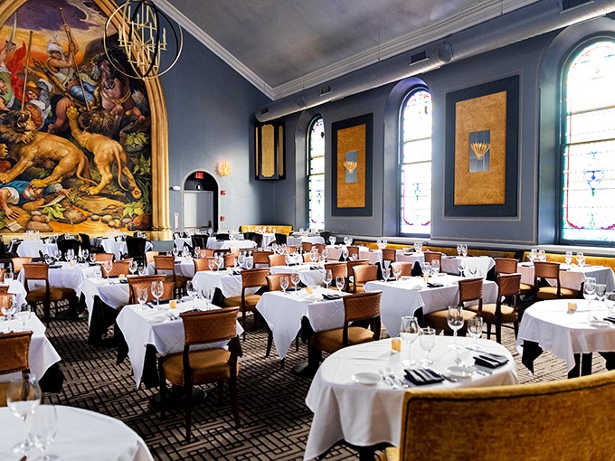 Blue walls and white tablecloths frame that show-stopping hunting mural&mdash;dining room or Renaissance museum? Either way, you're in for a masterpiece.
