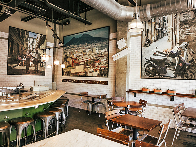 Industrial chic meets Italian warmth inside, where photographs of Naples transport you across the Atlantic before your pizza even arrives.