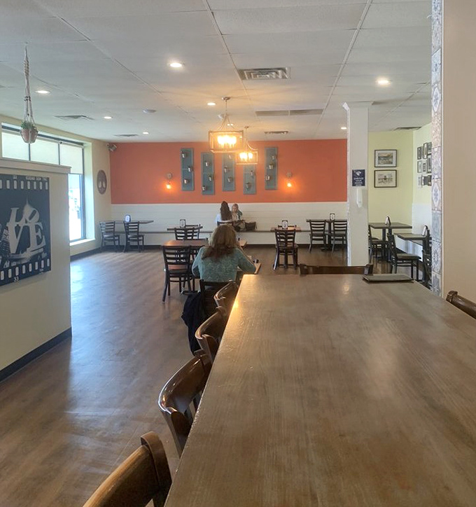 Warm coral walls, wooden tables, and that "LOVE" sign say it all &ndash; this isn't just a restaurant, it's a community living room where memories are made between bites.