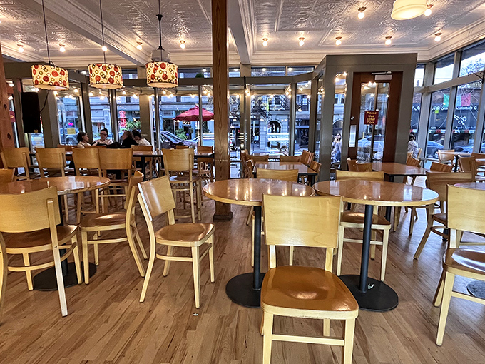 Warm wood tones and colorful pendant lights create the perfect backdrop for life-changing dessert decisions. The pressed tin ceiling whispers stories of countless sugar rushes.