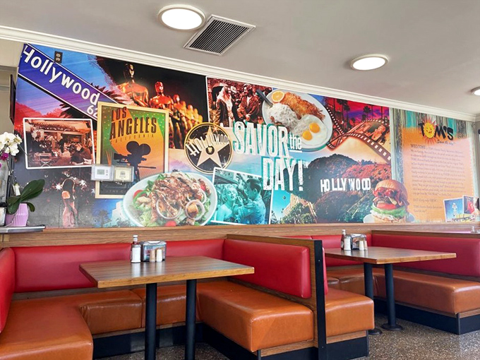Hollywood dreams line the walls while red vinyl booths cradle hungry patrons. The "SAVOR THE DAY!" mural isn't just decoration&mdash;it's a command you'll happily obey.