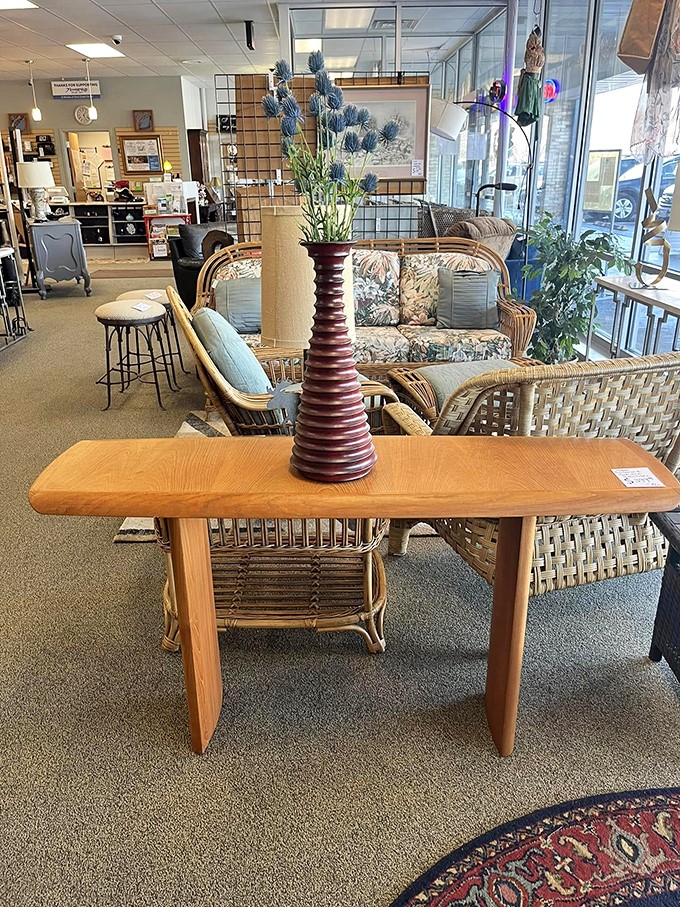 Mid-century wicker meets contemporary comfort in this furniture vignette. That spiral vase could easily be the star of a home design magazine spread.
