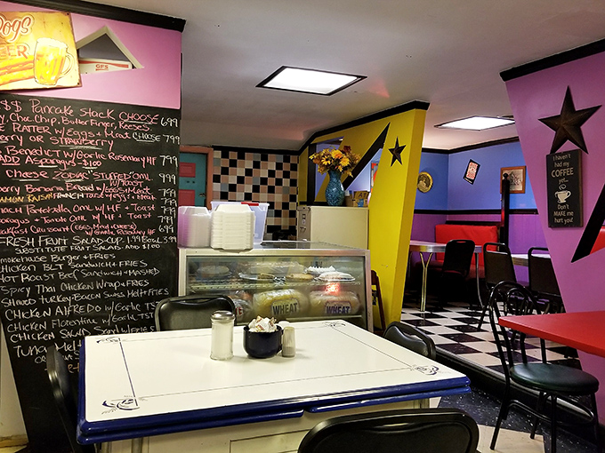 Step inside and the cosmic color scheme hits you&mdash;purple walls, yellow angles, and star decorations create a breakfast universe that's both nostalgic and totally unique.