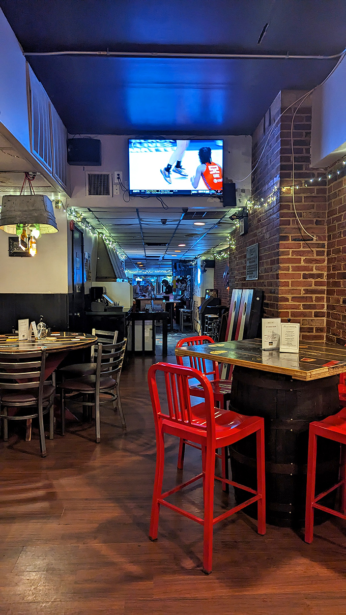 Inside Nick's, exposed brick meets those eye-catching red chairs, creating the perfect backdrop for sports watching and serious sandwich consumption.