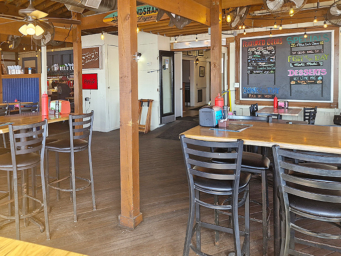 Rustic charm meets coastal comfort in The Shack's interior, where wooden beams and chalkboard menus promise authentic Florida dining without pretension.