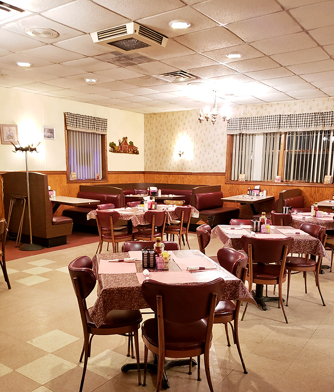 Classic diner booths and checkered curtains create the perfect backdrop for serious comfort food conversations.
