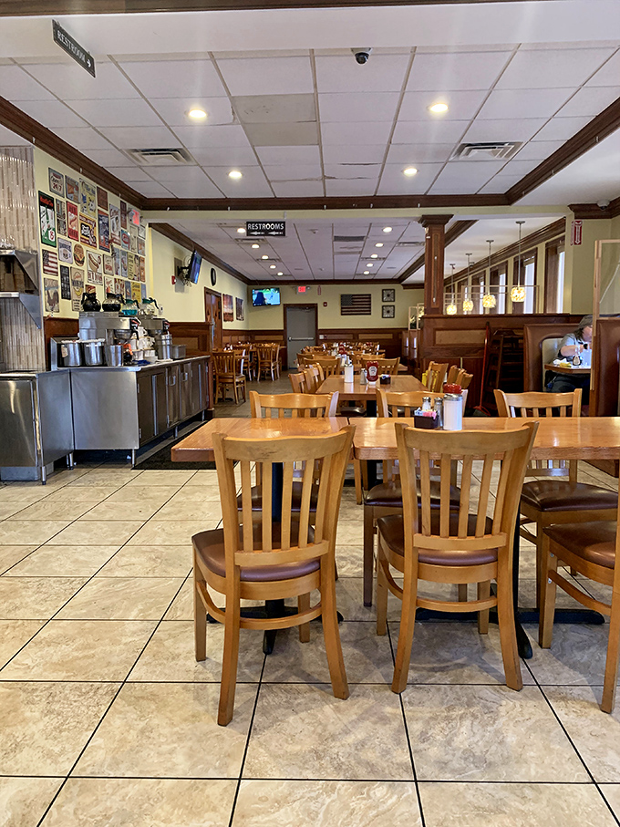 Classic wooden chairs and warm lighting create that quintessential diner atmosphere where conversations flow as freely as the coffee.