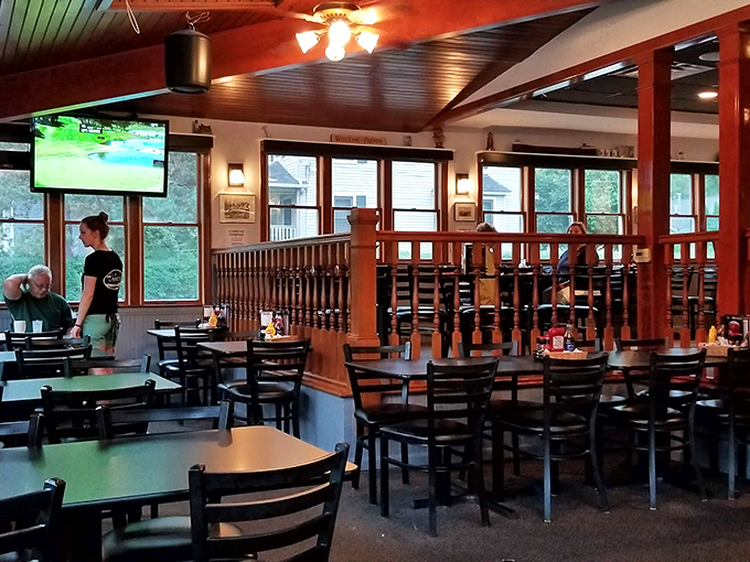 Warm wood railings divide cozy dining sections where conversations flow as freely as the drinks. The kind of place where everybody might know your name.