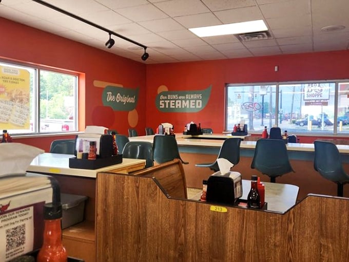 "Our BUNS are ALWAYS STEAMED" isn't just a slogan—it's a solemn promise made by the vibrant walls of this no-nonsense temple to tubular meat.