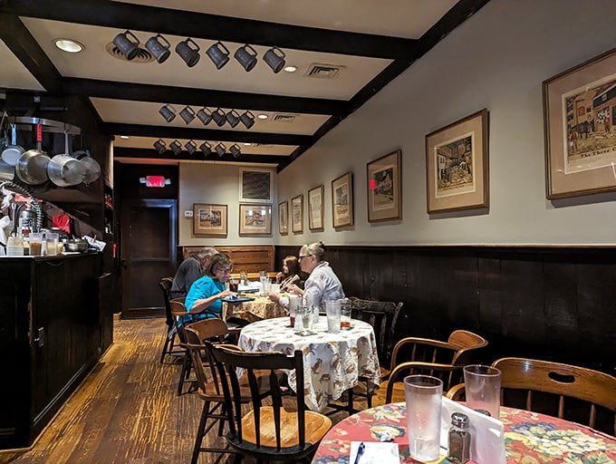 Where memories are made: wooden beams, patterned tablecloths, and mugs hanging overhead create that "been here forever" comfort we all crave.
