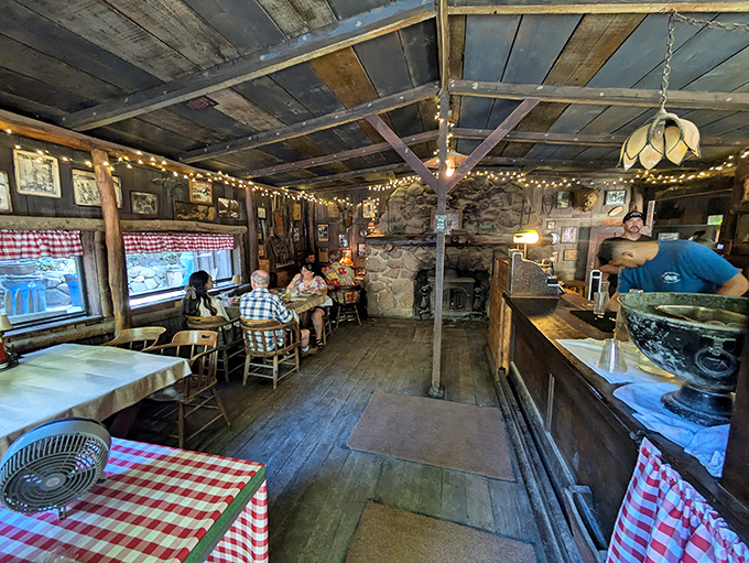 Where time stands deliciously still: Red-checkered tablecloths, wooden beams, and a stone fireplace create the perfect backdrop for making memories over hearty meals.