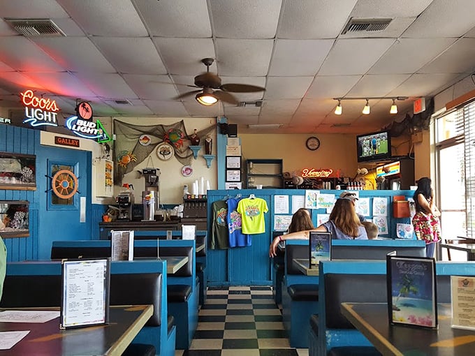 Classic diner aesthetics meet maritime charm inside Keegan's, where the blue booths and checkered floors set the stage for seafood stardom.