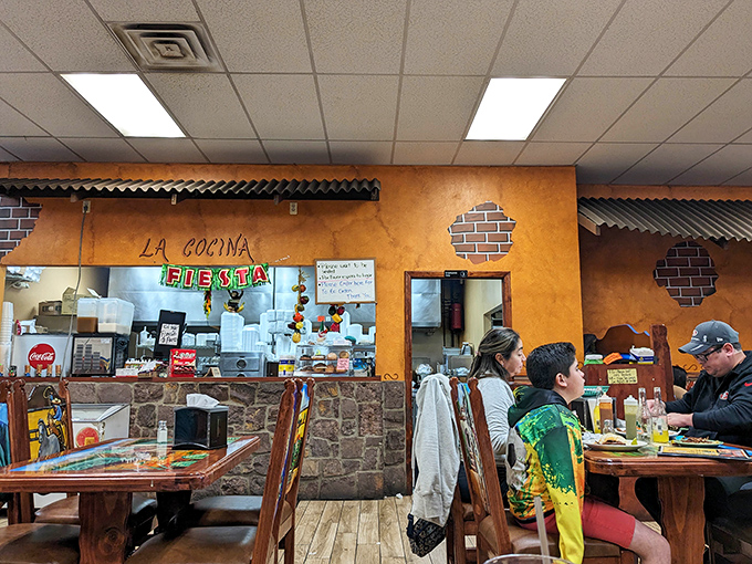 La Cocina – where the magic happens. The open kitchen design lets you witness culinary artistry in action while colorful papel picado flutters overhead.