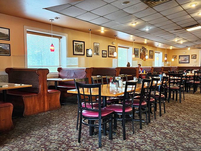 Classic diner ambiance with burgundy booths and simple tables &ndash; where conversations flow as freely as the coffee refills.