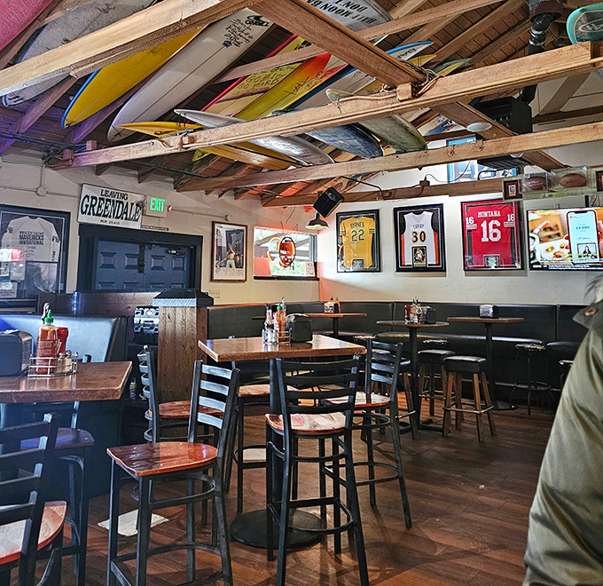 Surfboards suspended from wooden rafters tell stories of epic waves, while sports memorabilia creates the perfect backdrop for both first dates and longtime regulars.