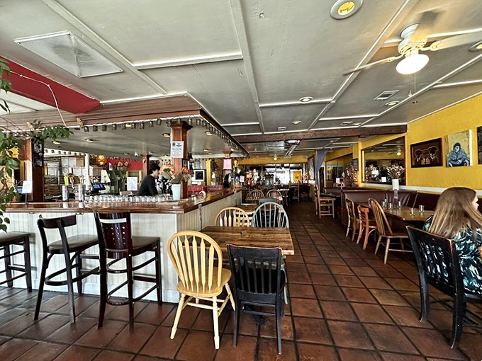 Inside, mismatched chairs and terra cotta floors create that rare "everybody knows your name" vibe without the hassle of actually being Norm.