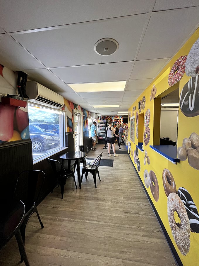 Yellow walls adorned with donut imagery create a cheerful pathway to sugar-laden bliss. The anticipation builds with every step.
