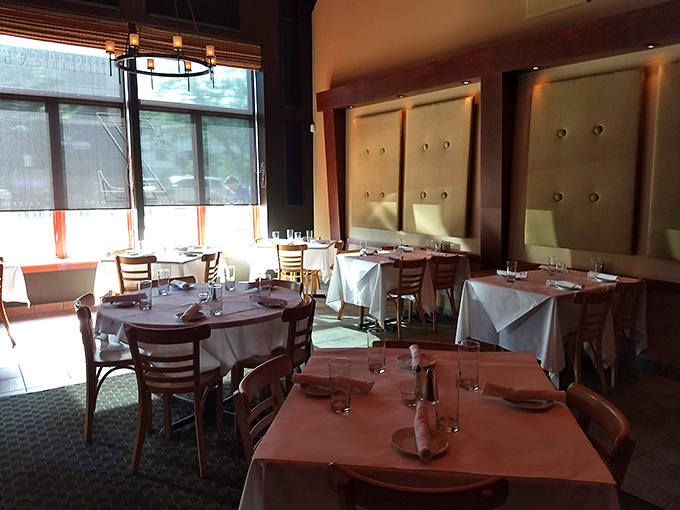 White tablecloths and warm wood tones create an atmosphere that says "special occasion" without shouting it. Elegance without pretension is the Z Cucina way.