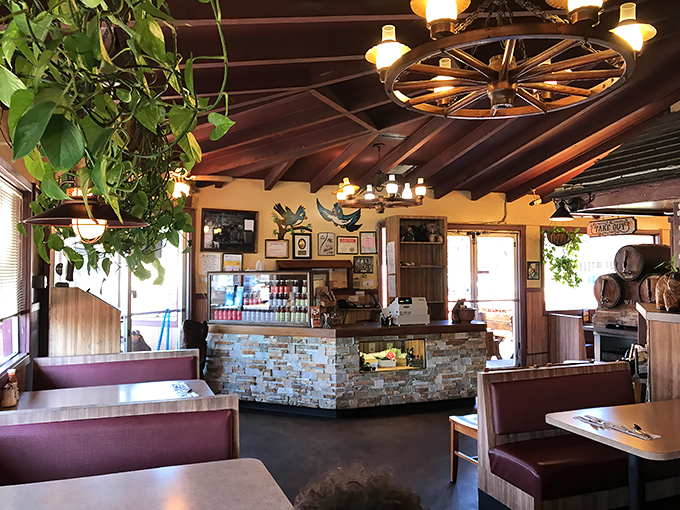 Step inside and you're transported to BBQ heaven. Wagon wheel chandeliers, wooden beams, and hanging plants create that perfect "come stay awhile" vibe.