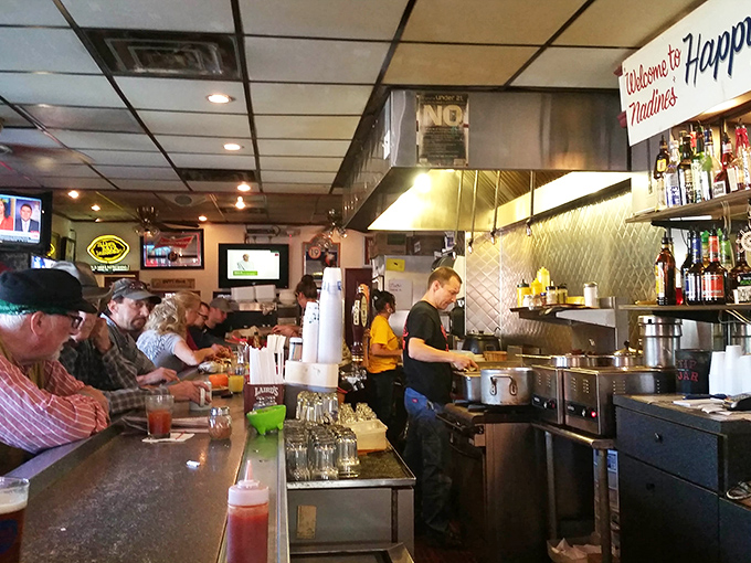 The bustling counter at Nadine's showcases the beautiful choreography of short-order cooking, where breakfast dreams become reality before your eyes.