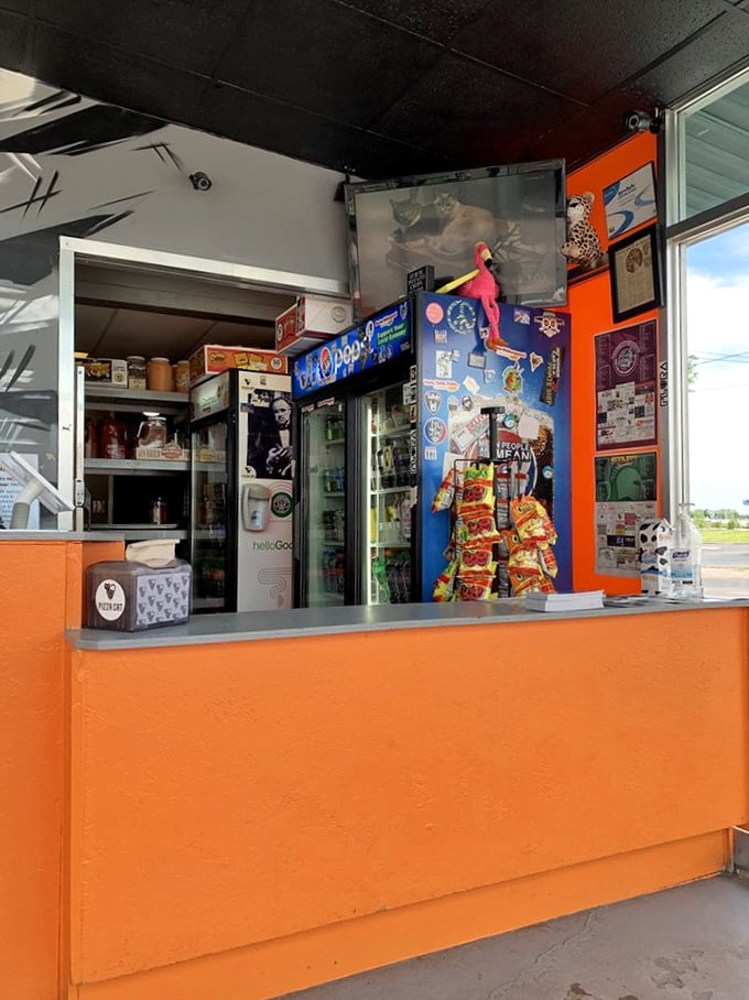 Behind this unassuming counter, pizza magic happens. Note the bags of Hot Cheetos standing by, ready for their unconventional but delicious duty.