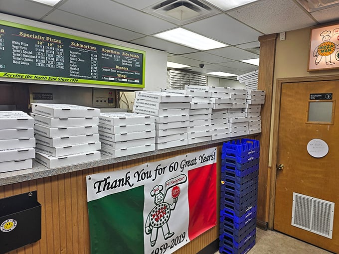Step inside this wood-paneled time machine where pizza boxes stack like edible skyscrapers of neighborhood pride.