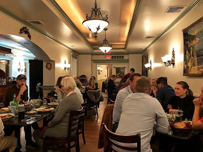 Classic elegance meets neighborhood comfort in this warmly lit dining room where magic happens nightly.