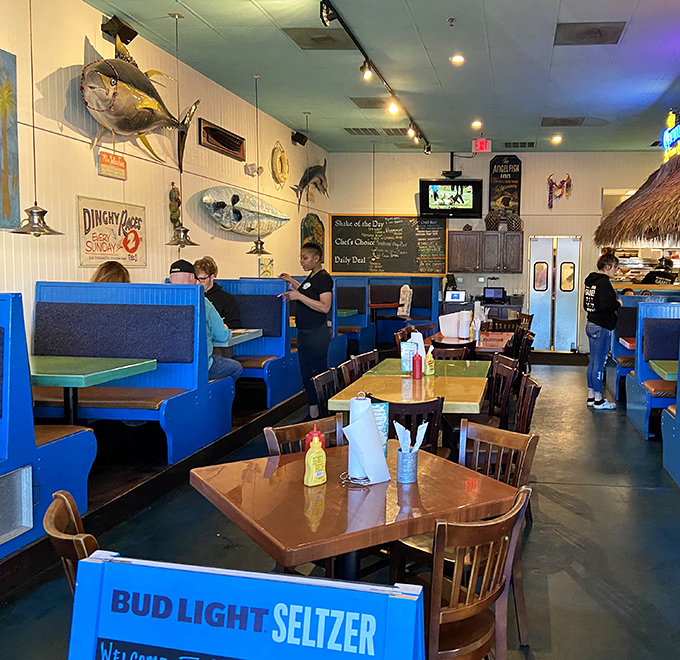 Vibrant blue booths and mounted fish create that perfect "coastal casual" vibe where flip-flops are always appropriate attire.