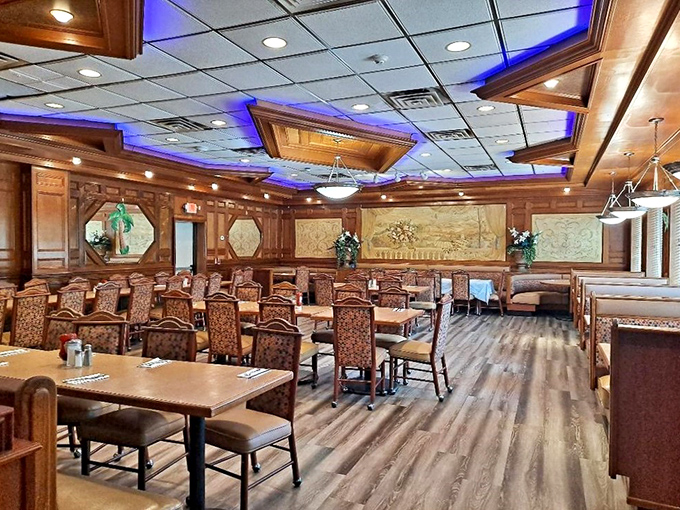 Step inside to discover a dining room where wood paneling meets modern blue lighting—comfort and class sharing the same dance floor.