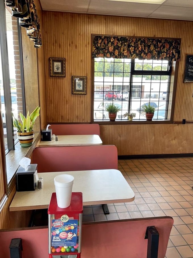 Wood paneling and vintage red booths create that perfect time-capsule atmosphere where conversations flow as freely as the coffee, complete with a gumball machine for the young at heart.