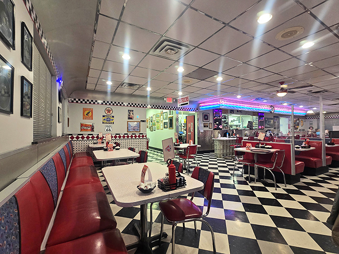 Step inside and the checkerboard floor, red vinyl booths, and neon lighting transport you to an era when Elvis was king and milkshakes were considered a food group.