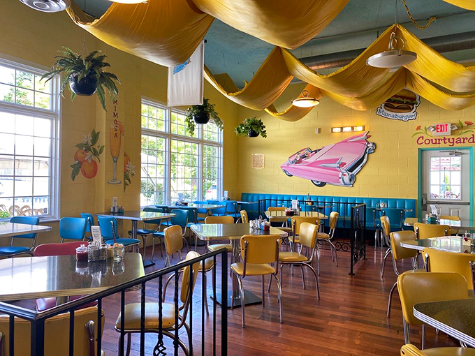 Step inside and you're transported to a retro wonderland where fabric waves overhead like a golden sea and that pink Cadillac mural promises automotive-sized portions.