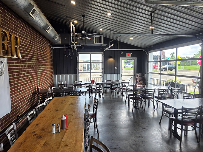 Industrial chic meets small-town charm in this dining space where exposed brick and metal ceilings create the perfect backdrop for serious meat consumption.