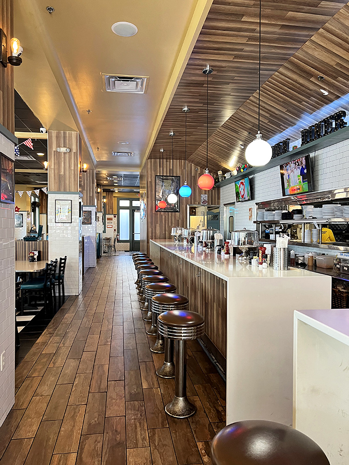 Classic diner dreams come true inside this wood-paneled wonderland, where chrome stools await and pendant lights cast the perfect Instagram glow.