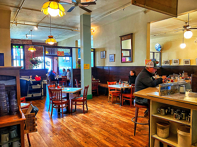 Warm wooden floors, exposed brick, and vintage lighting create that perfect "where everybody knows your name" vibe that makes breakfast feel like coming home.