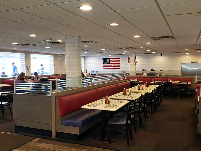 Classic red booths and an American flag create the perfect backdrop for life's big decisions: western omelet or chocolate chip pancakes?
