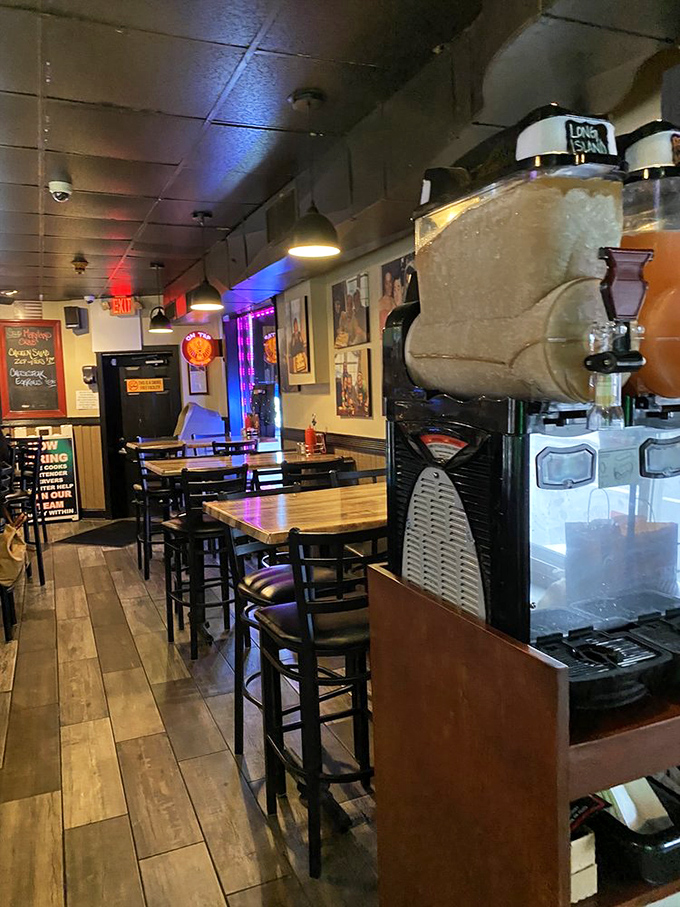 The interior strikes that perfect balance between neighborhood pub and comfort zone, where wooden tables invite you to linger and neon lights set the mood.