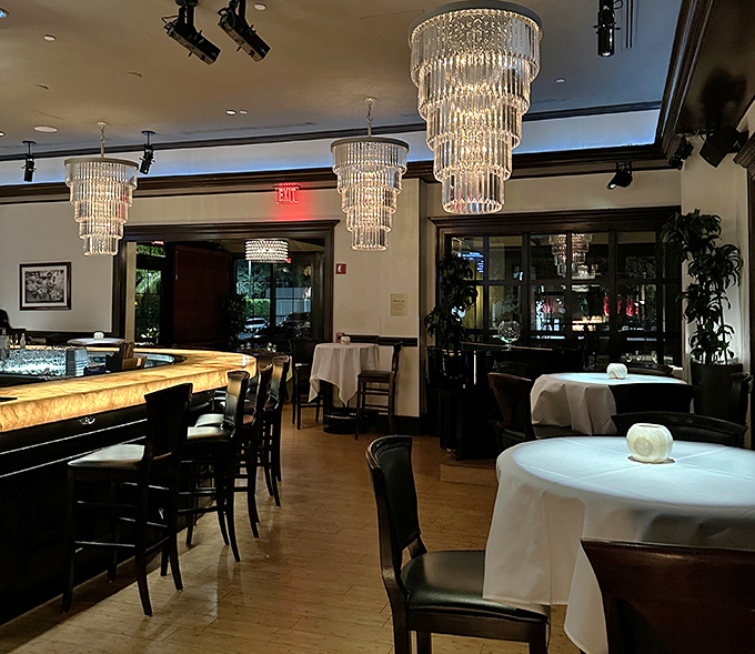 Crystal chandeliers dance overhead while white tablecloths await your elbows. It's like dining in a wealthy friend's living room—if that friend had impeccable taste.