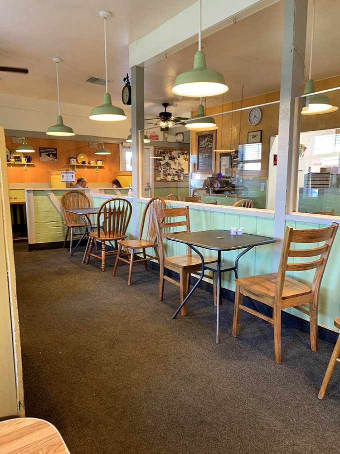 Mint green walls, wooden chairs, and pendant lights create that rare atmosphere where conversations flow as smoothly as the coffee refills.