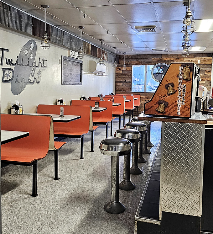 Classic orange booths and chrome stools create that perfect diner atmosphere where comfort food and conversation flow equally freely.