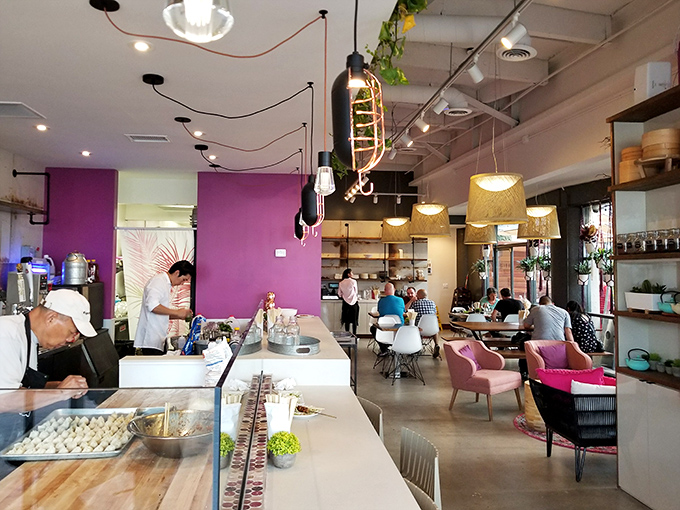 Purple accent walls and hanging pendant lights create the perfect backdrop for dumpling artisans crafting little pockets of joy before your eyes.
