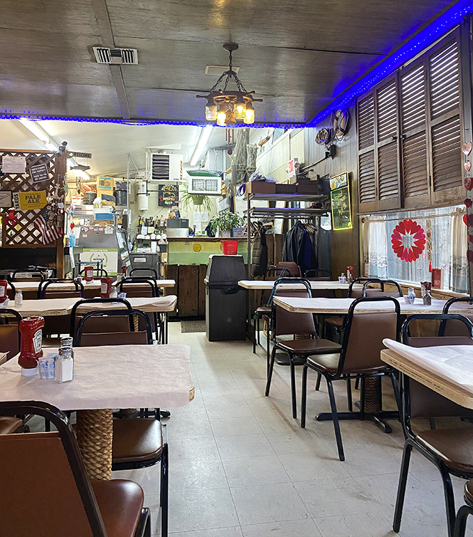 Blue lights cast an oceanic glow across simple tables where countless seafood feasts have unfolded. Unpretentious perfection at its finest.